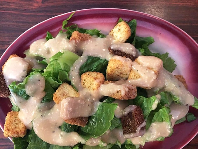 Crisp romaine, creamy dressing, and croutons that actually crunch—salad never looked so inviting here.