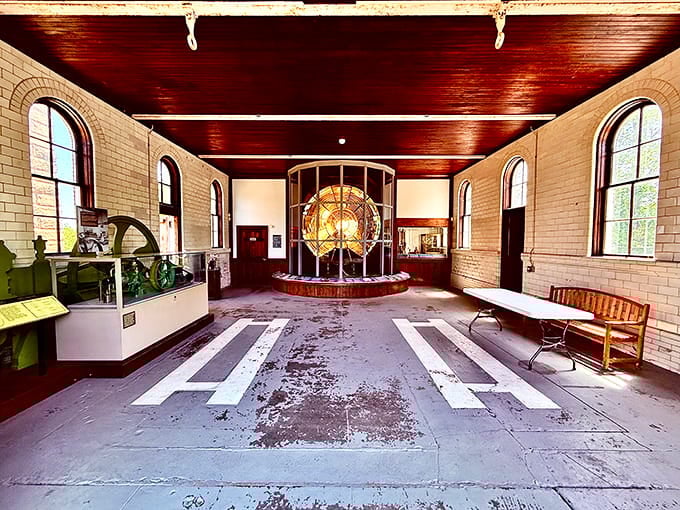 Inside, rich wood ceilings and arched windows frame the massive Fresnel lens like a jewel display.