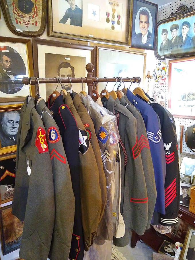 History you can wear. These military uniforms stand at attention against a backdrop of the faces who may have worn them.