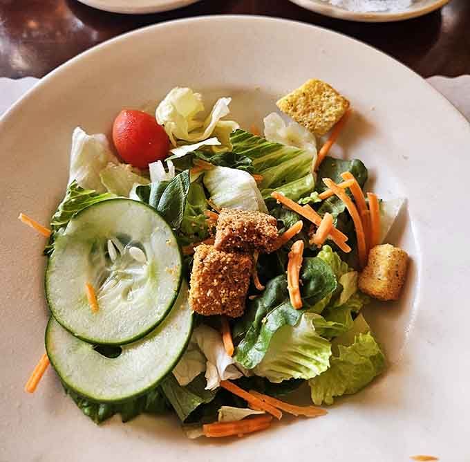 Fresh, crisp, and topped with homemade dressing, this salad is the opening act that doesn't get booed off stage.