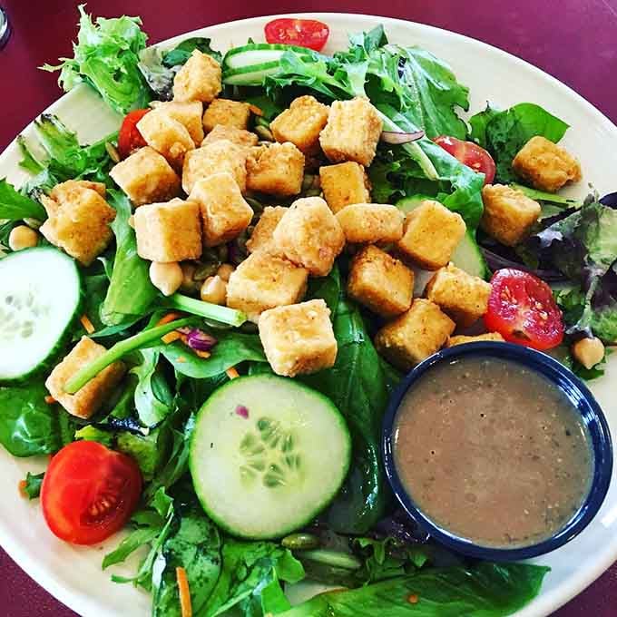 A fresh salad topped with crispy croutons proves that even the lighter options here get the royal treatment.