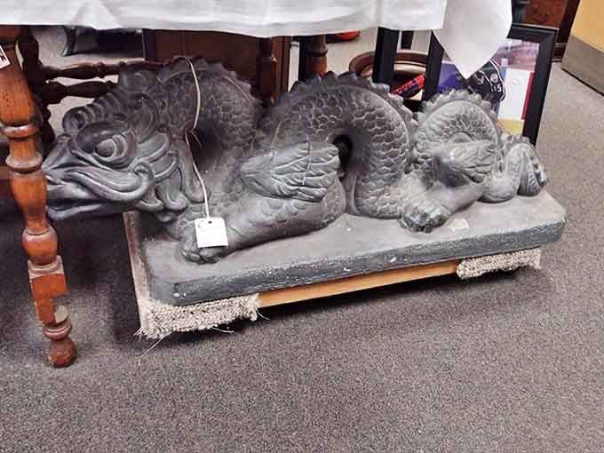 Who needs garden gnomes when you can have this magnificent stone dragon guarding your petunias? This sleeping beast has probably witnessed more shopping expeditions than a mall Santa in December.