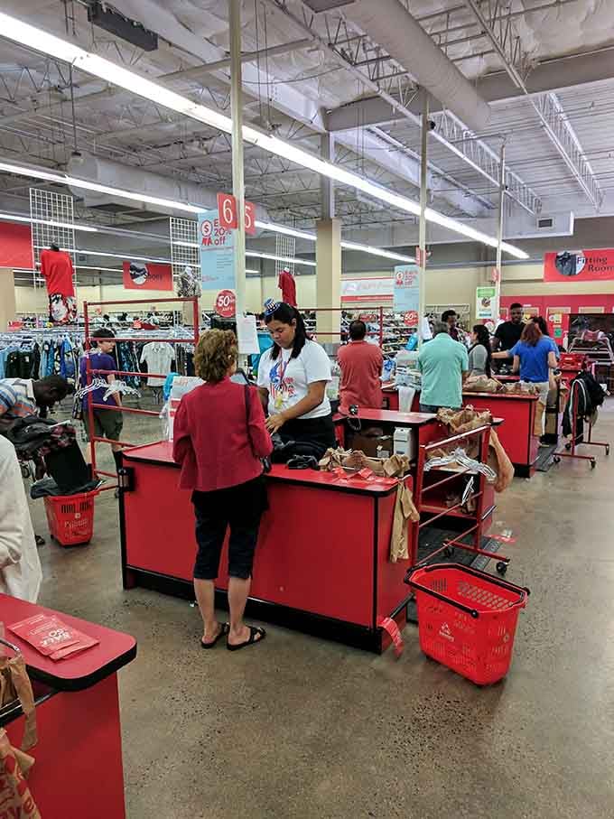 Checkout time: where treasure hunters converge, red baskets brimming with finds that spark both joy and "how much?!" disbelief.