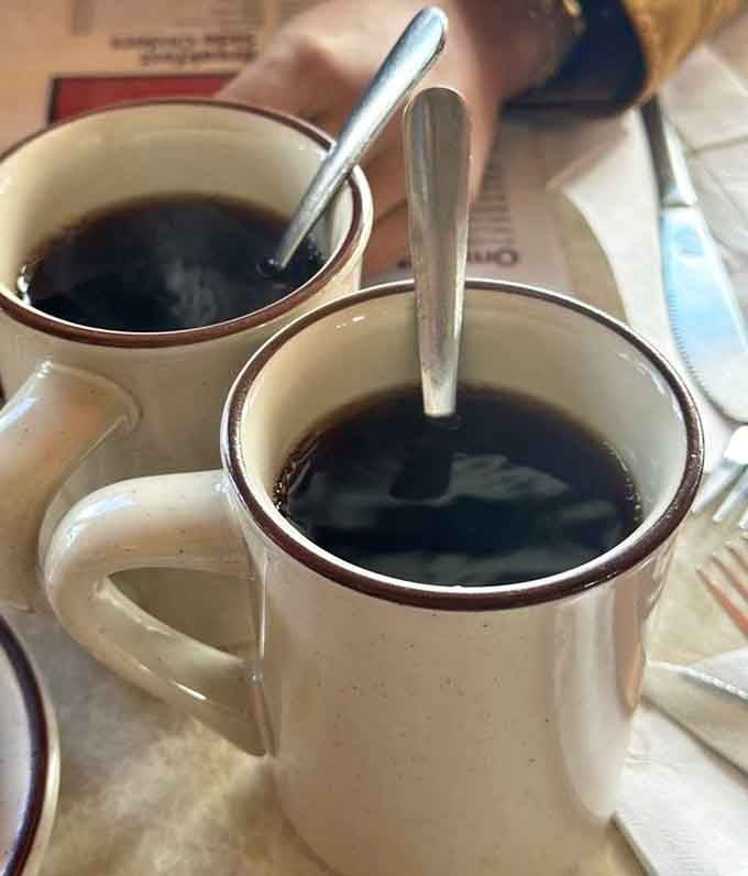Coffee served in those heavy ceramic mugs that somehow make it taste better than any fancy pour-over. The lifeblood of diners everywhere, kept hot and flowing.
