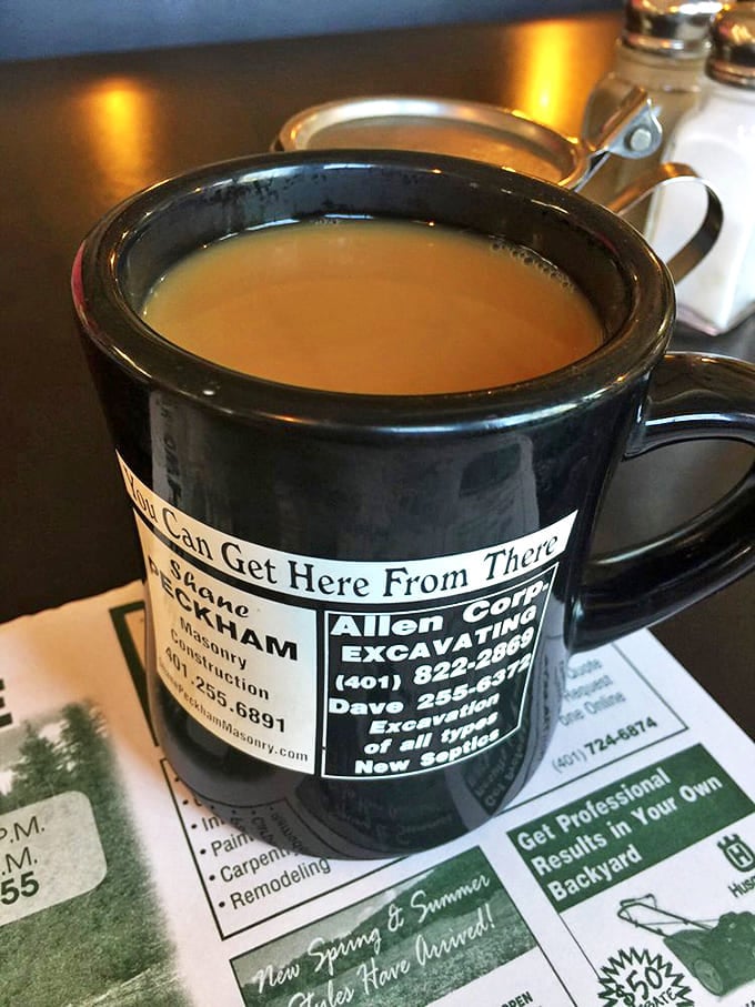 The coffee comes in mugs advertising local businesses &ndash; because nothing says "authentic diner" like sipping from a cup that could direct you to a good plumber.