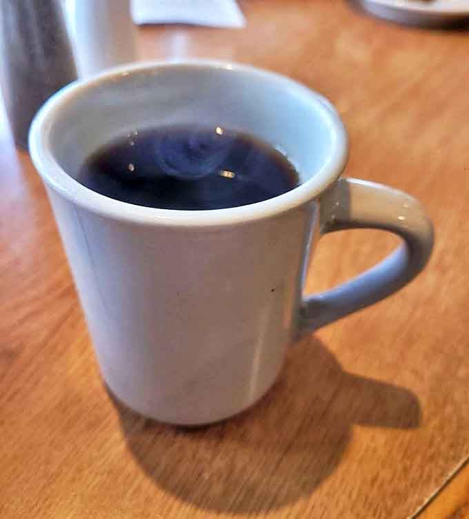 Simple pleasures: Hot coffee in a sturdy mug, ready to fuel conversations about crops, weather, and local gossip.