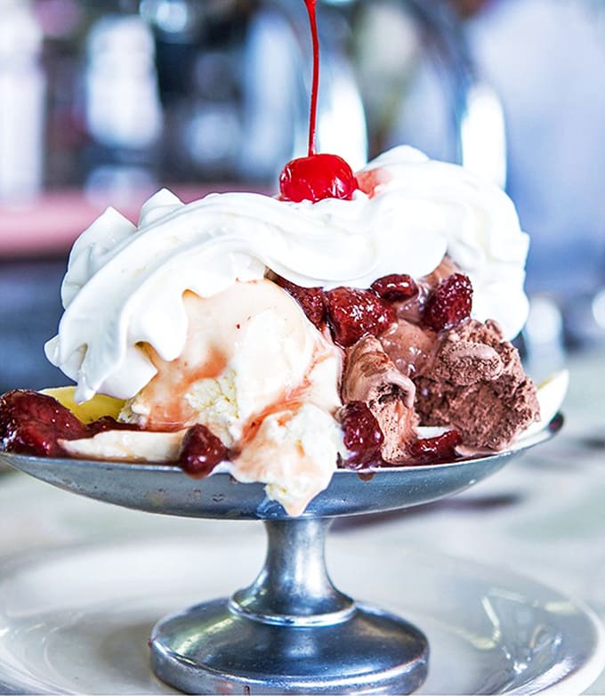 Ice cream sundae architecture at its finest&mdash;where whipped cream mountains meet cherry-topped peaks in a dish that defies both gravity and restraint.
