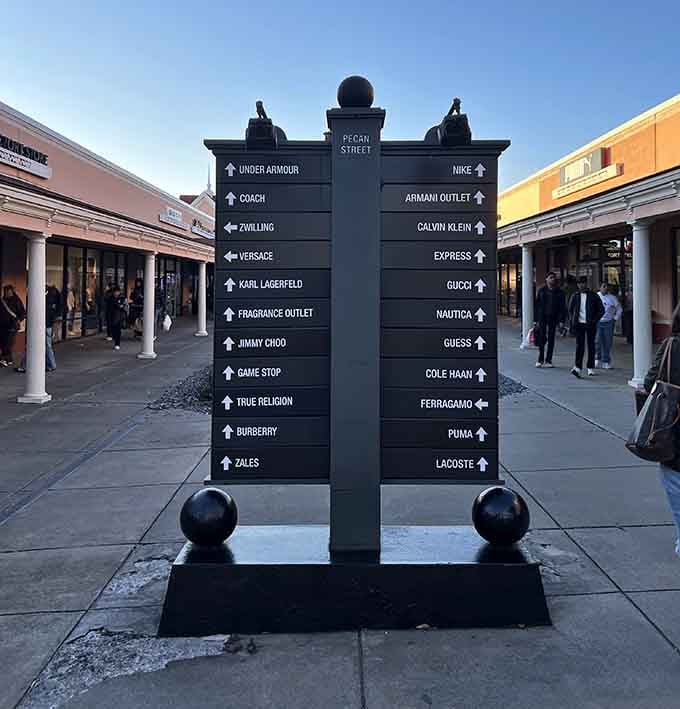 The directional sign&mdash;a shopper's North Star guiding you from Burberry to Puma without getting lost in a sea of savings.