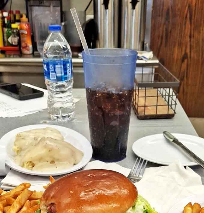 The classic American diner tableau: a hearty burger, crispy fries, and a tall soda&mdash;the holy trinity of roadside satisfaction.