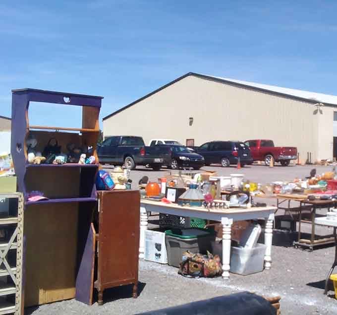 The parking lot tells its own story: pickup trucks loaded with potential treasures next to sedans ready to haul away unexpected finds.
