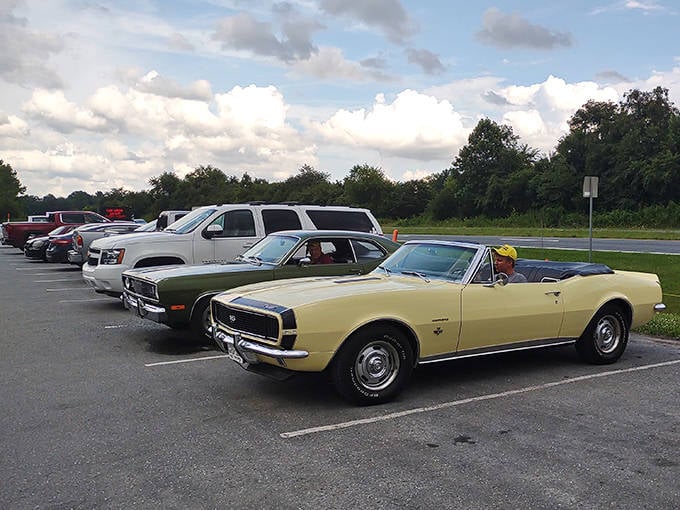 Classic cars mingle in the parking lot, including this pristine Camaro convertible. Even the visitors' vehicles tell stories here.