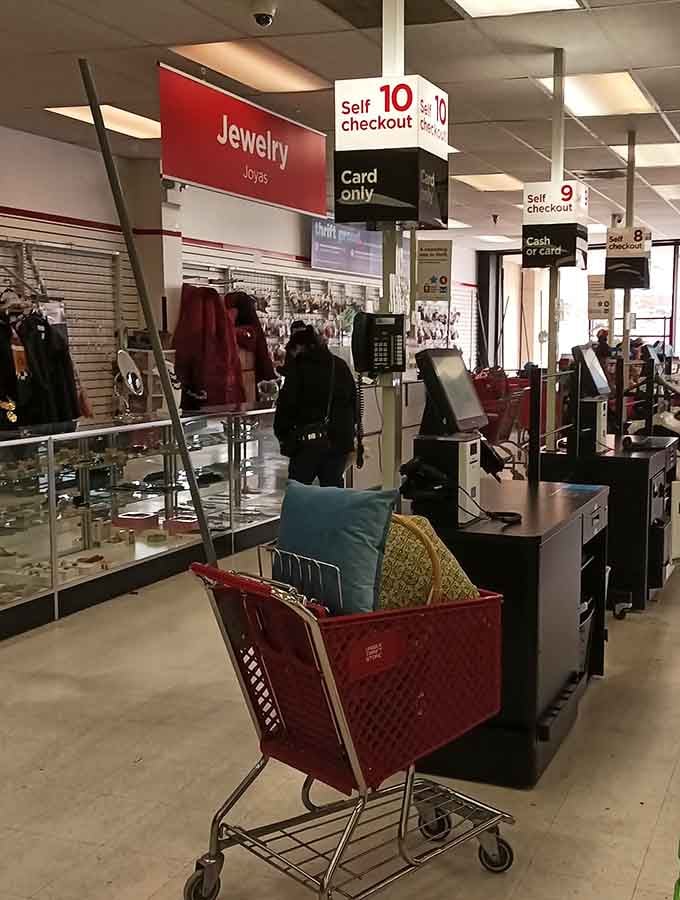 Where the treasure hunt concludes. Self-checkout stations await with red shopping carts brimming with newfound treasures and unexpected discoveries.