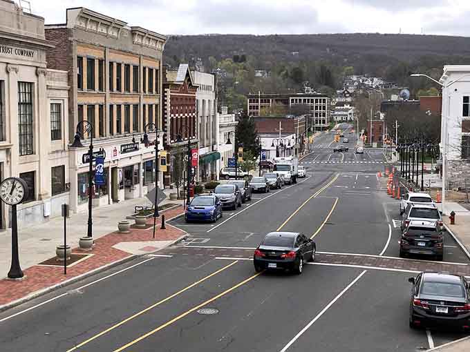 Downtown slopes gently toward the hills beyond, where classic storefronts and street clocks create an inviting small-city atmosphere.