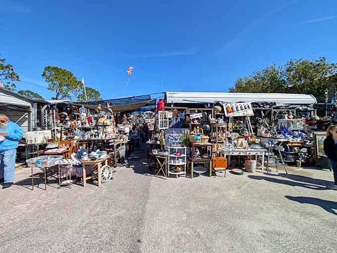 Outdoor vendor tents stretch toward the horizon under blue skies where bargain hunting becomes a competitive sport.