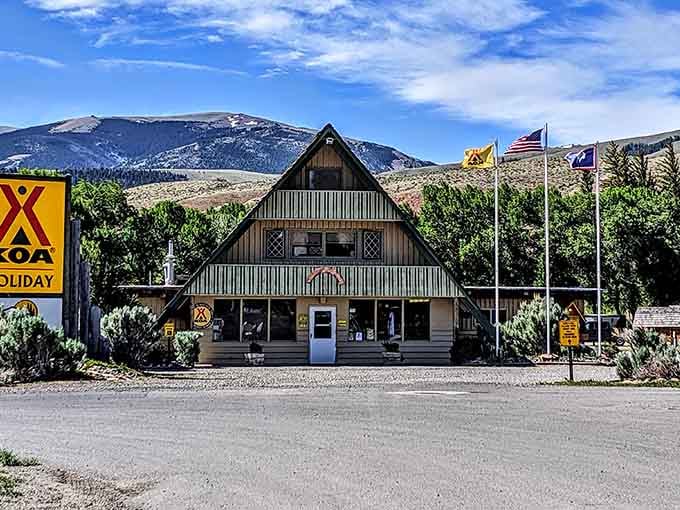 The A-frame KOA office in Dubois stands sentinel against mountain backdrops, a wooden welcome mat for wilderness adventures.