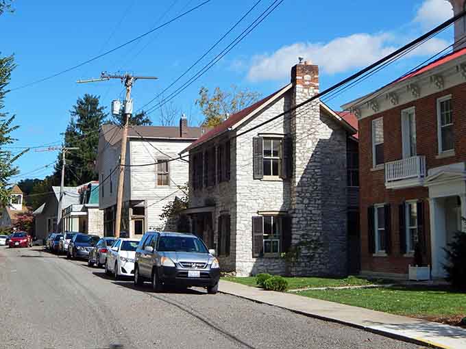 Stone cottages huddle together on this quiet lane, their limestone walls glowing warmly in the afternoon autumn sunlight.