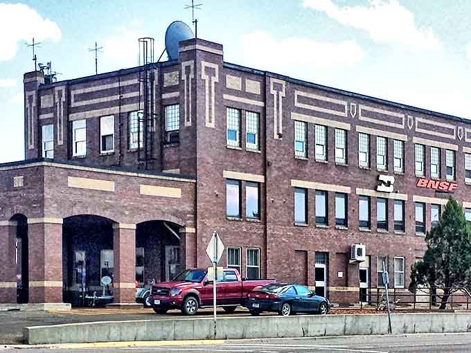 The historic BNSF Railway building in Glendive stands proud like a brick sentinel, watching over generations of Montana stories with quiet dignity.