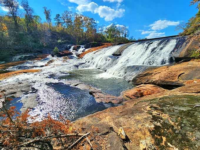 Majestic waterfalls pour over the dam while that historic structure stands strong against time and weather.
