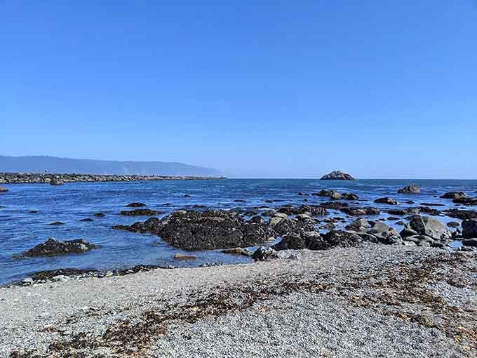 Rocky tide pools dot the shoreline where waves meet land, creating nature's own aquarium for curious explorers.