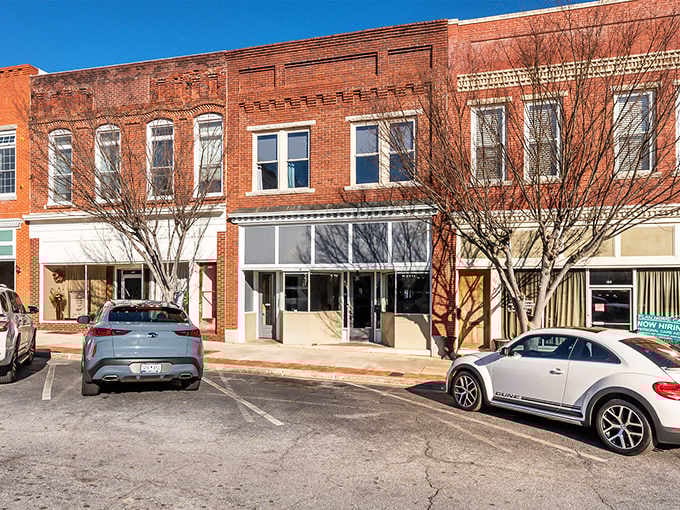 Brick storefronts stand shoulder to shoulder like old friends who've weathered every economic storm together since Eisenhower.