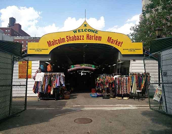 The bold yellow archway beckons visitors into a vibrant marketplace celebrating culture, craftsmanship, and community spirit.