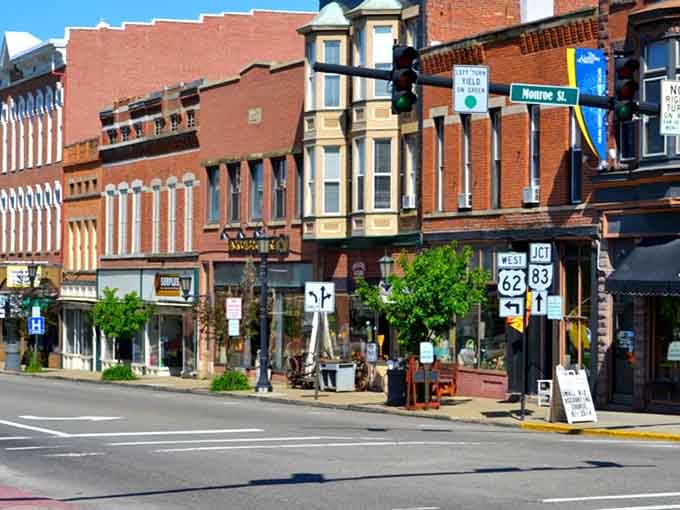 Historic storefronts march down the street in perfect formation, their varied facades telling stories of different eras and styles.