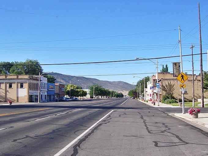 Empty roads lead toward mountain horizons, symbolizing the freedom that comes with truly affordable small-town living.