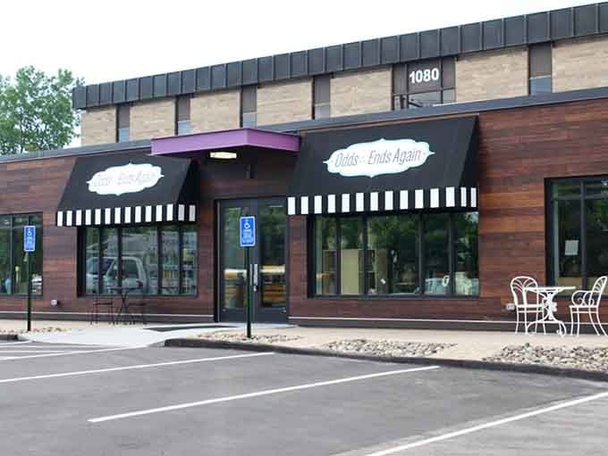 The distinctive striped awning and wood-paneled exterior create a sophisticated shopping experience that feels more boutique than thrift.