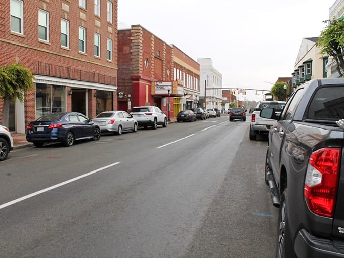 Classic brick buildings house local businesses where that vintage cafe sign beckons like a friendly wave from yesteryear.