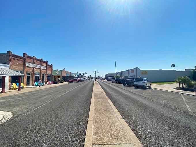Those painted storefronts pop with color against blue skies, each building wearing its personality like your favorite comfortable sweater.