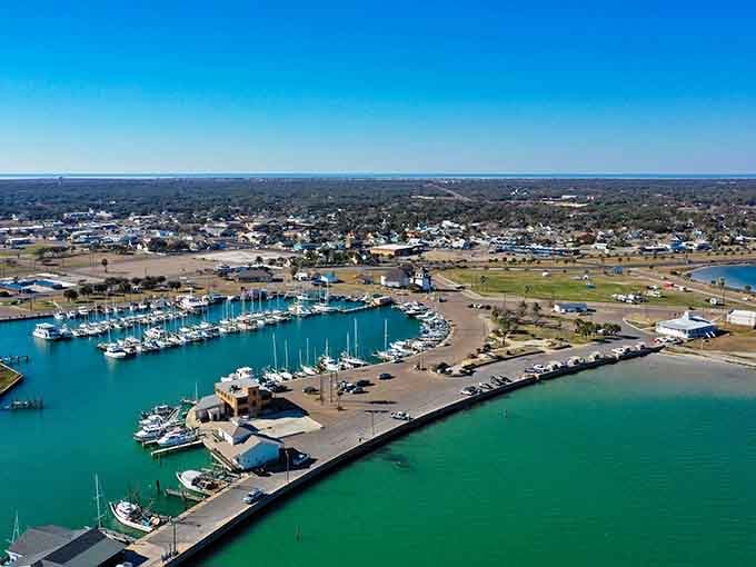 Marina waters shimmer in brilliant turquoise as sailboats bob gently, creating a scene of pure coastal tranquility.