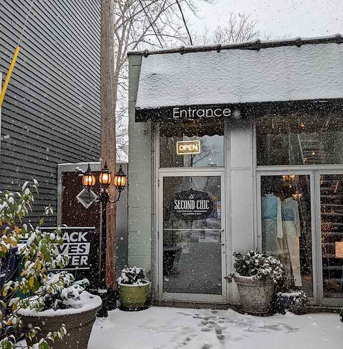 Fresh snowflakes dust the entrance of this charming consignment shop, creating a cozy winter shopping scene in Buffalo.