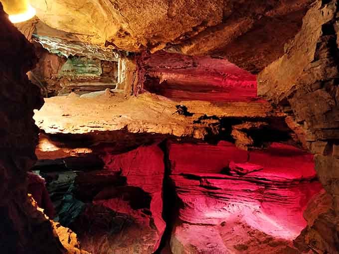 Dramatic lighting transforms these underground chambers into a glowing wonderland of crimson and gold hues.