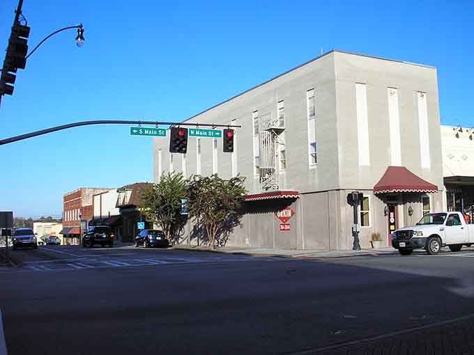 Statesboro's historic downtown corner where Main Street meets Southern charm under a perfectly blue Georgia sky.