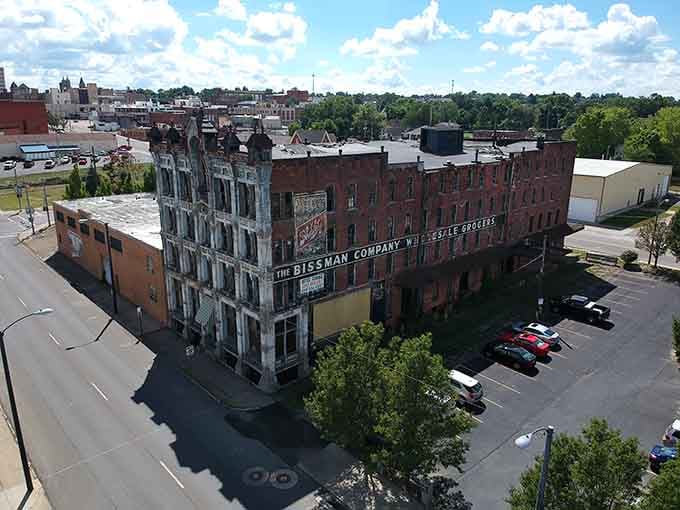 This weathered brick giant towers over downtown streets, its empty windows watching the world change below for generations.