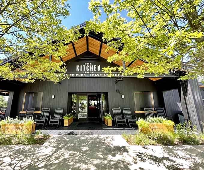 The modern black barn design with that welcoming motto proves sometimes new construction can feel like coming home.