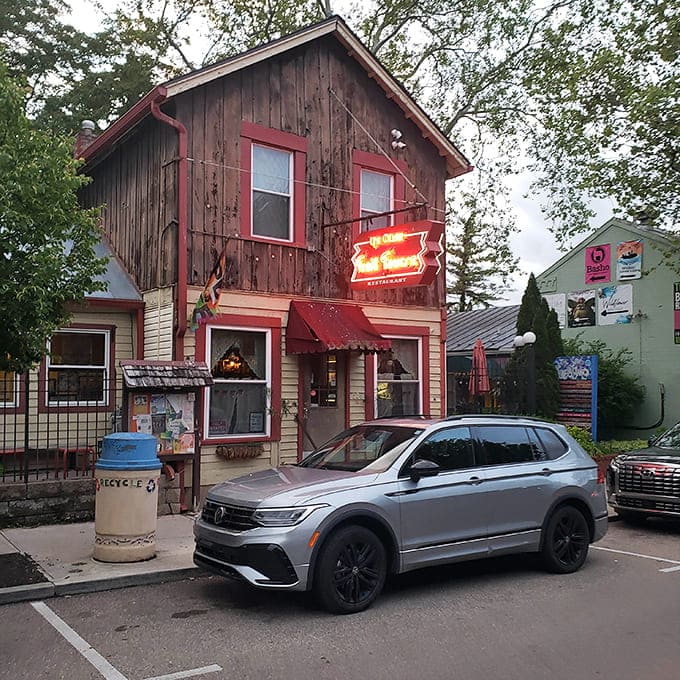 This weathered two-story building wears its history like a badge of honor, standing proud among the neighborhood homes.