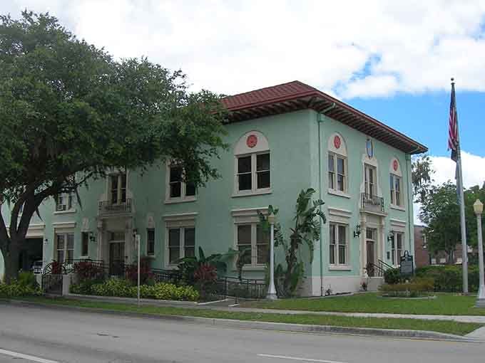 Mint-green walls and terra-cotta roof tiles give this building a Mediterranean flair that stands out beautifully.