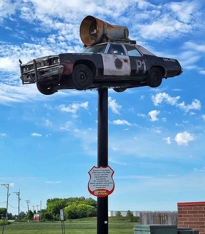 Defying gravity and good sense, this mounted police cruiser looks perpetually mid-chase, complete with megaphone and vintage charm.
