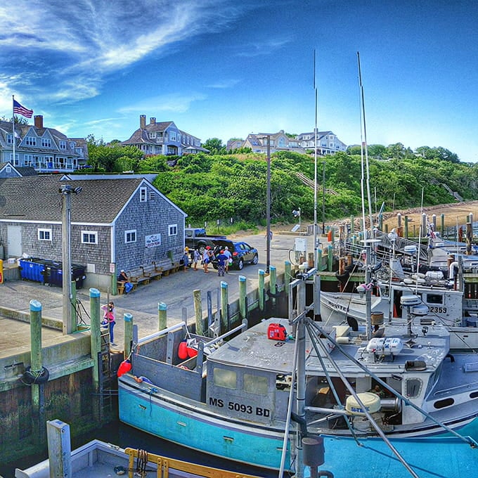 Classic fishing boats docked beneath stately homes: a postcard-worthy slice of maritime life.