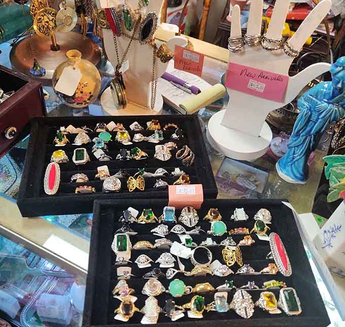 Vintage rings sparkle in velvet trays like tiny time machines ready to transport you back to glamorous eras.