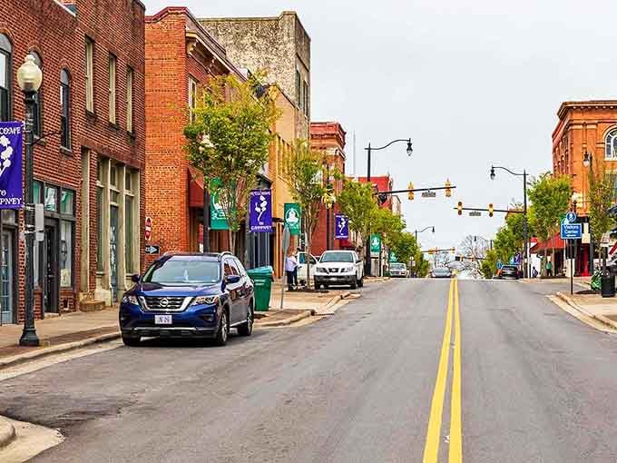 Main Street stretches ahead like a promise kept, lined with shops that remember when service meant something.