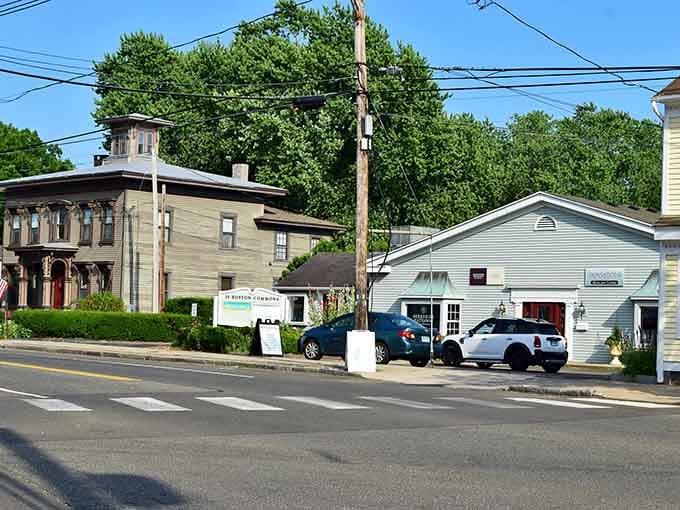 Small-town architecture meets everyday life where historic buildings share space with modern cars and community gathering spots.