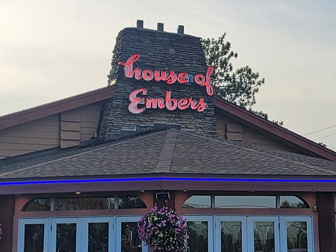 The neon glow of "House of Embers" promises warmth inside, both from the hospitality and the perfectly cooked steaks.