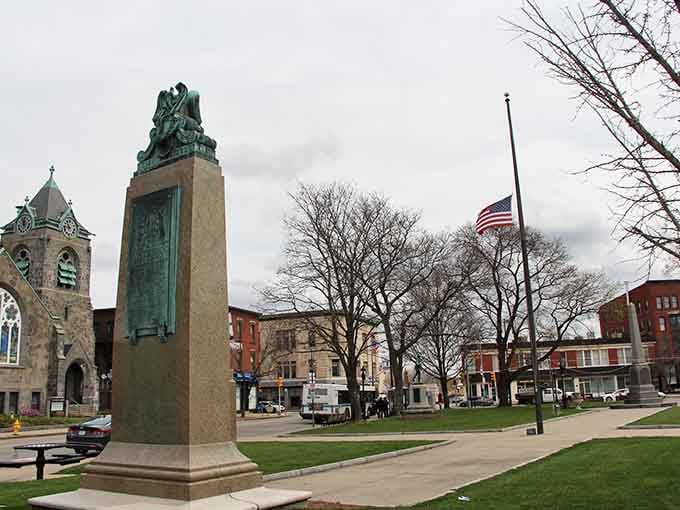 That weathered monument stands sentinel over the town common, a copper-green reminder that history never really leaves these streets.