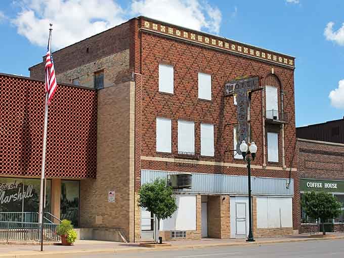 Classic American flags wave proudly above storefronts where local businesses have served generations of families with genuine care.
