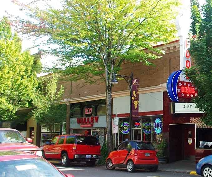 Sunlight filters through leafy trees along McMinnville's main drag, where local shops and restaurants invite exploration on a perfect Oregon afternoon.