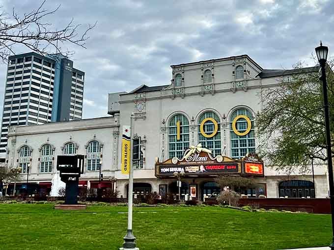 The grand theater facade glows with vintage elegance, promising entertainment like they made it in Hollywood's golden age.