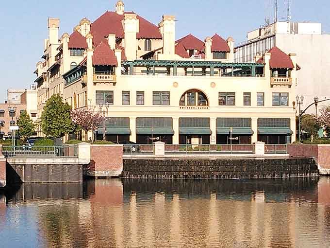 Red-tiled roofs reflect in the waterway, creating a mirror image of California's Spanish colonial influence.