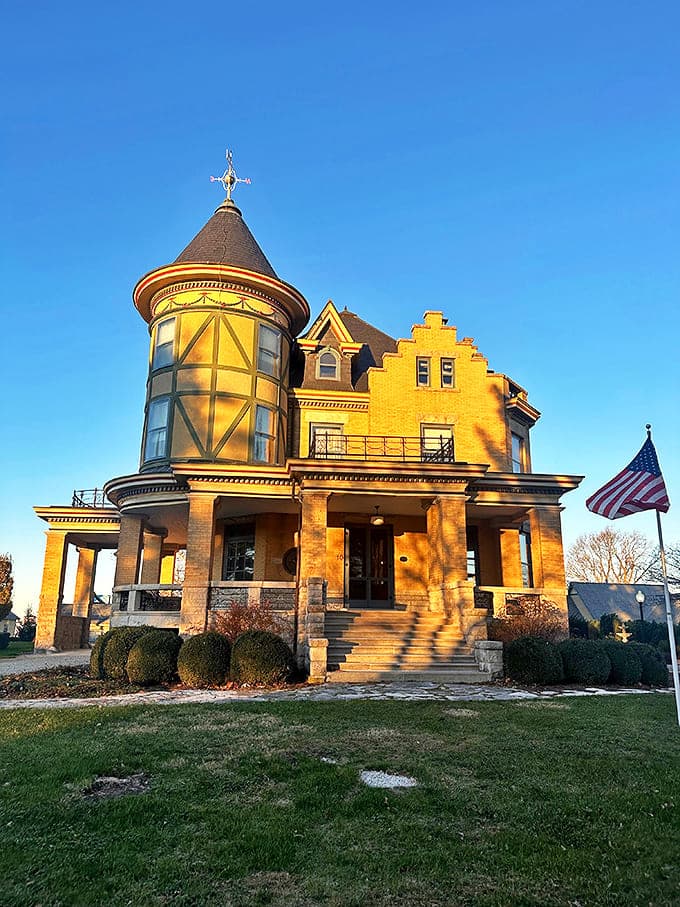 The Castle's golden brick and distinctive round tower with glass windows capture the morning sunlight beautifully.